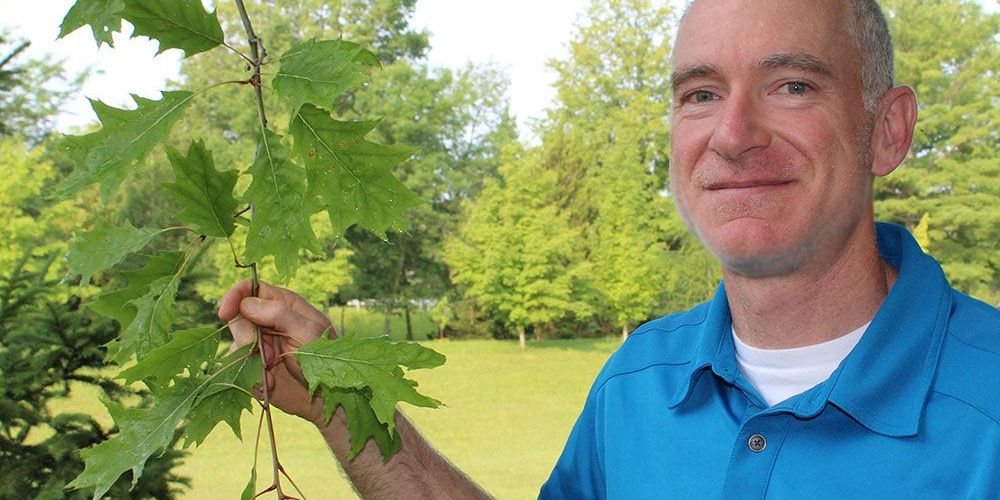 ABCA Forestry and Land Stewardship Specialist Ian Jean holds a branch ...